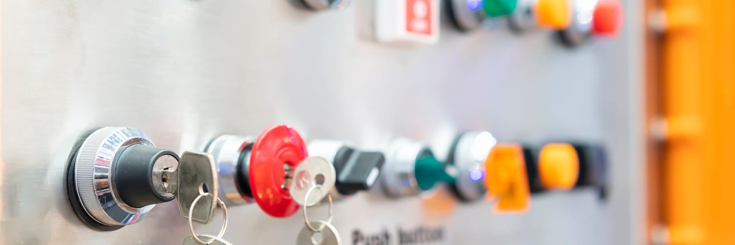 How does an emergency stop button work?